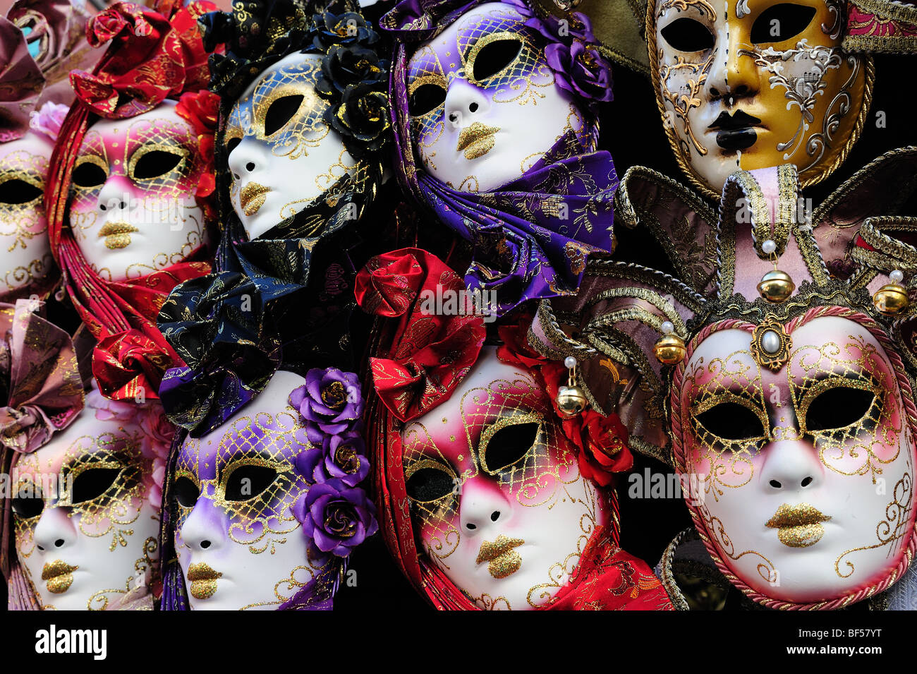Row of Venetian face masks on display for sale at a stall in a Venice ...