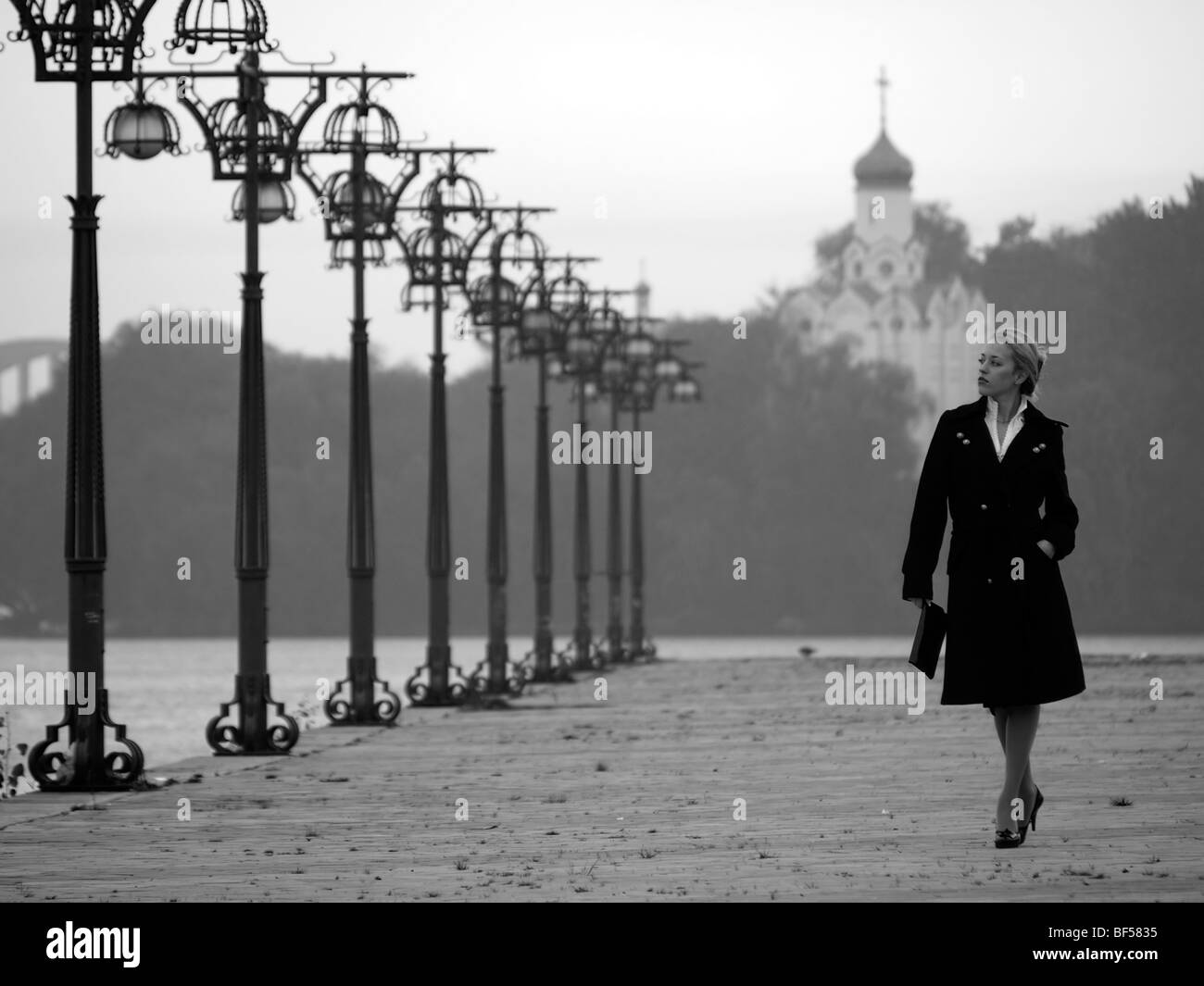 Beautiful trendy blonde lady walking over promenade Stock Photo - Alamy