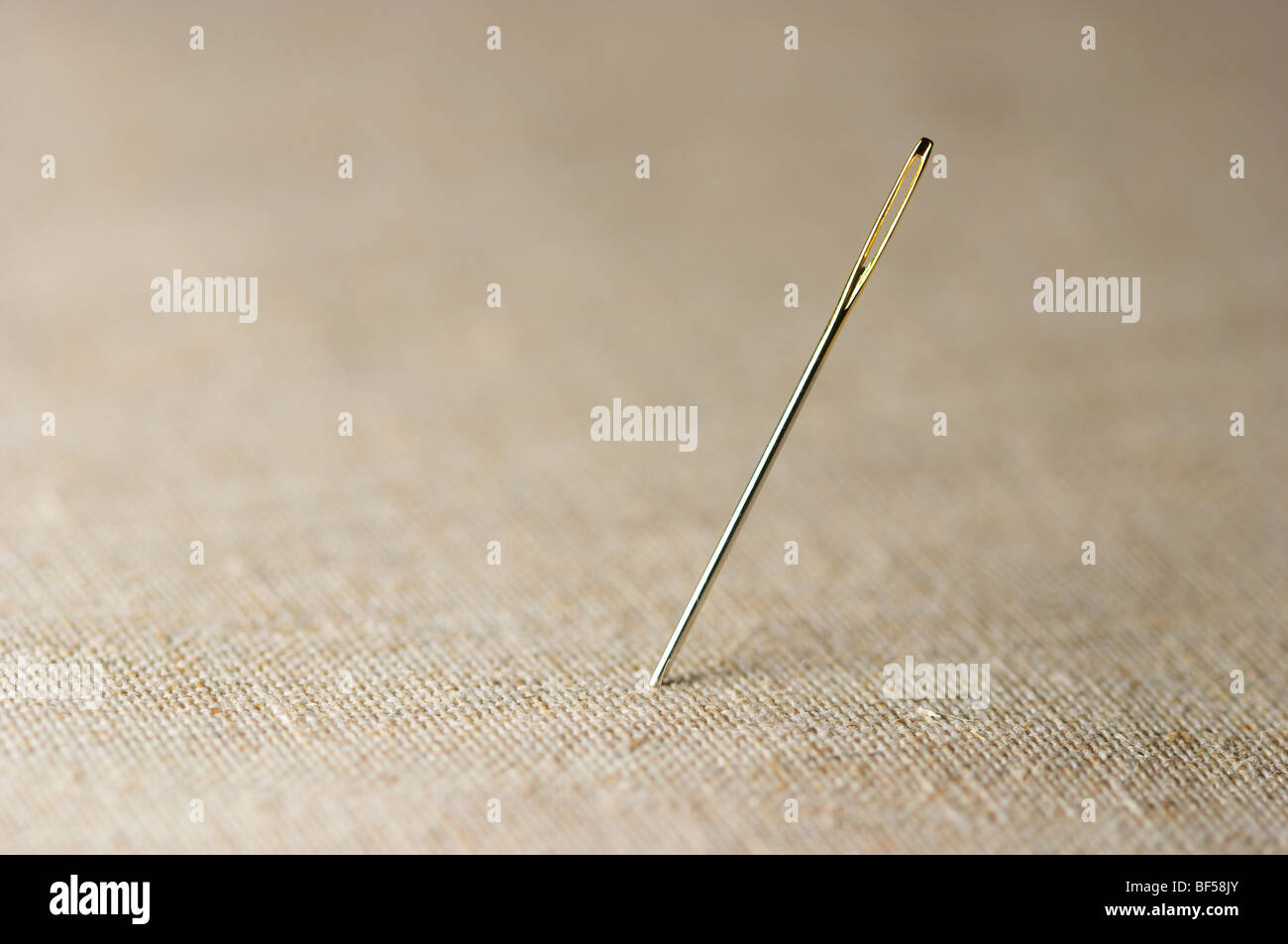Closeup of needle on linen cloth background Stock Photo - Alamy