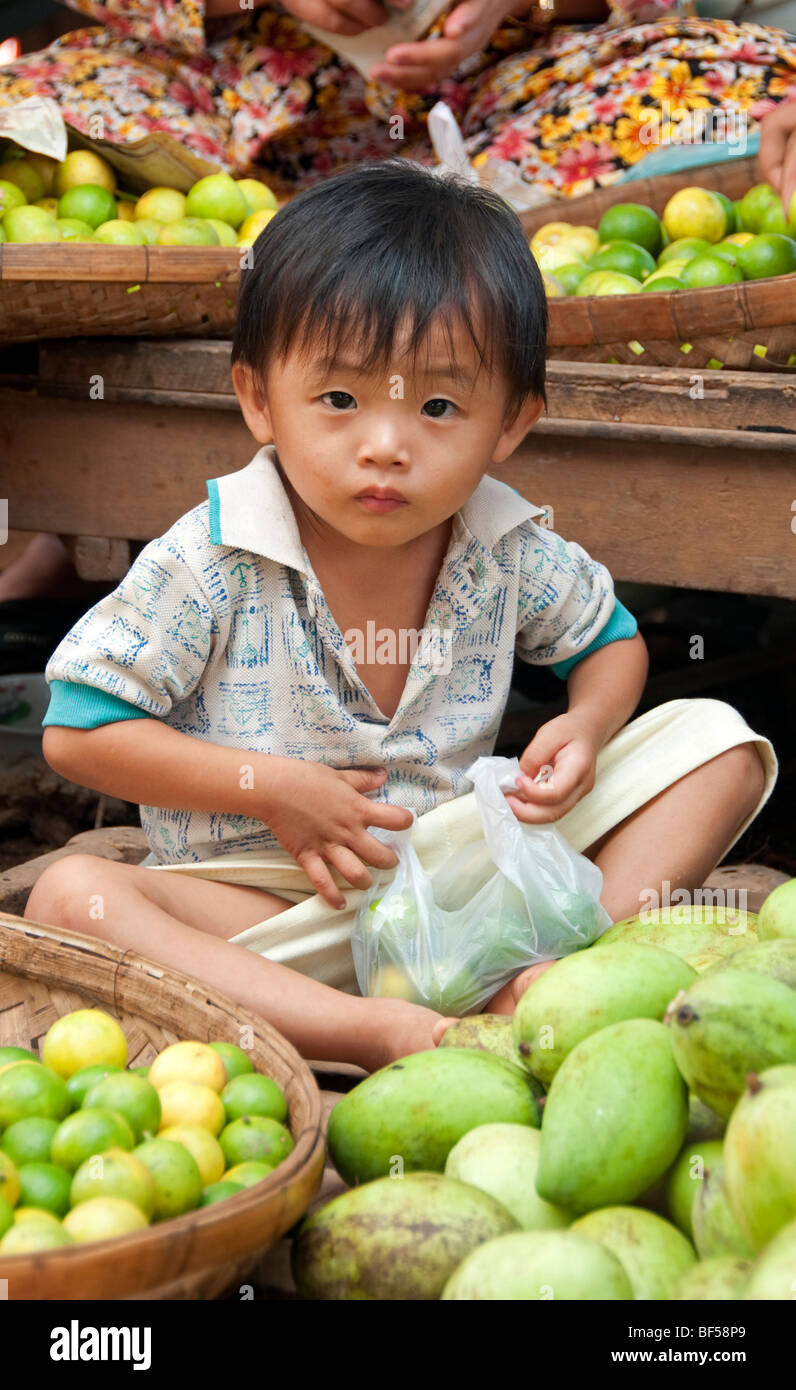 Boy selling fruit at a market in Skuon, Cambodia Stock Photo - Alamy