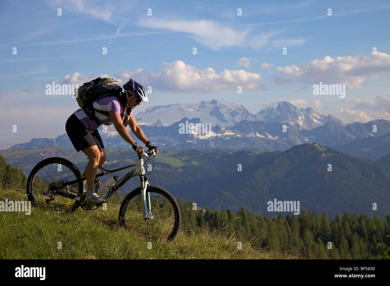 Mountain bike rider on single trail at Mt. Kreuzkofel, in the back Mt ...