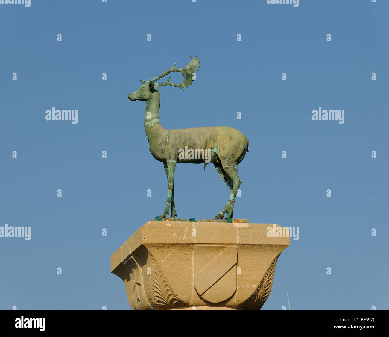 The bronze stag Elafós at the port entrance of Mandraki, Rhodes Town ...
