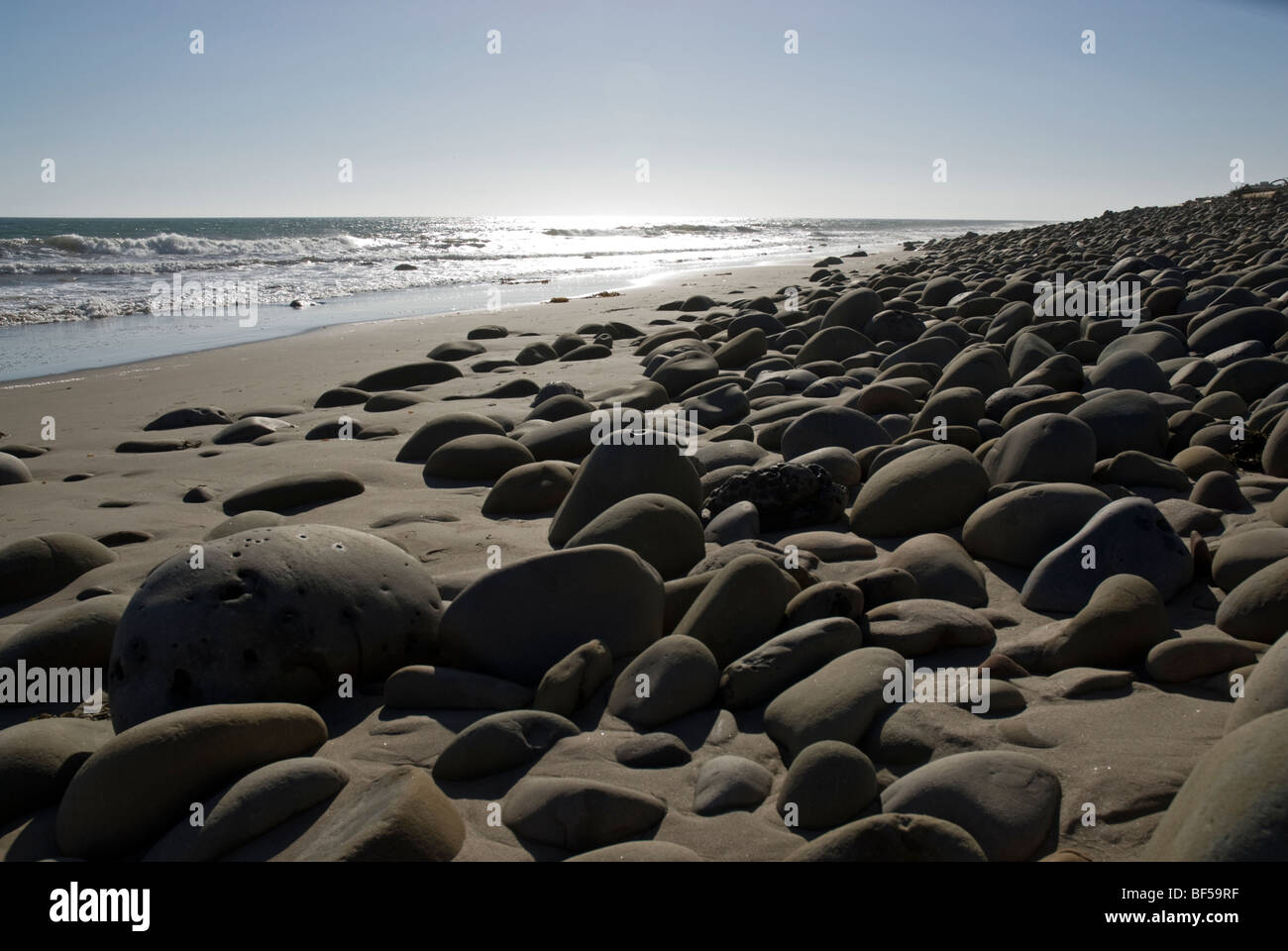 Rocks leading to a beach and the ocean at Emma Wood State Beach ...