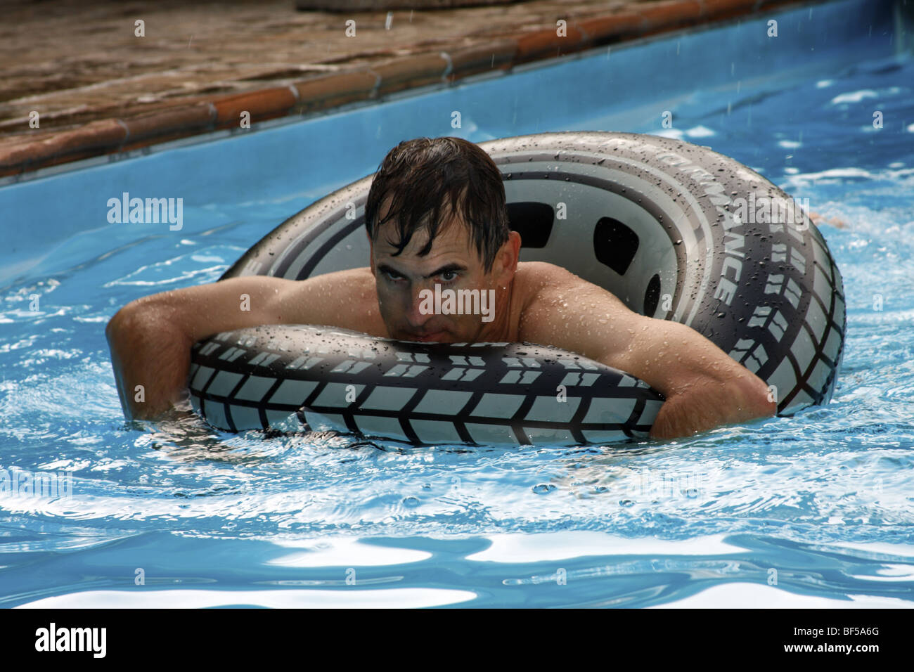 Man floating in an inner tube hi-res stock photography and images - Alamy