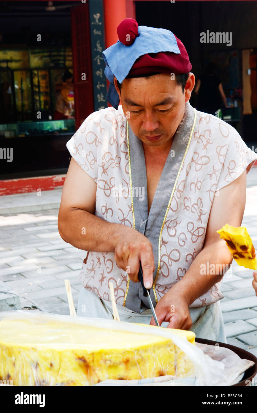 Street vendor in Song Dynasty attire selling sticky rice cake ...