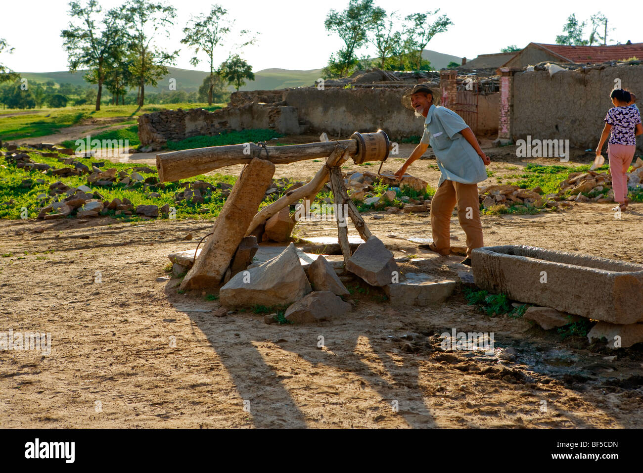 Old farmer using a well to draw water, Sichuan Province, China Stock ...