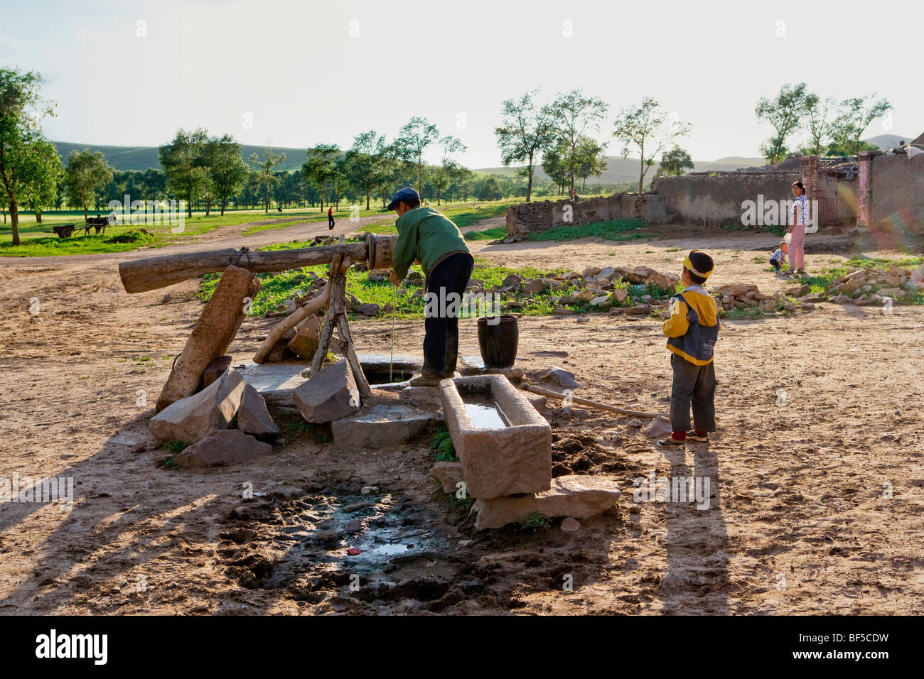 Farmer using a well to draw water, Sichuan Province, China Stock Photo ...