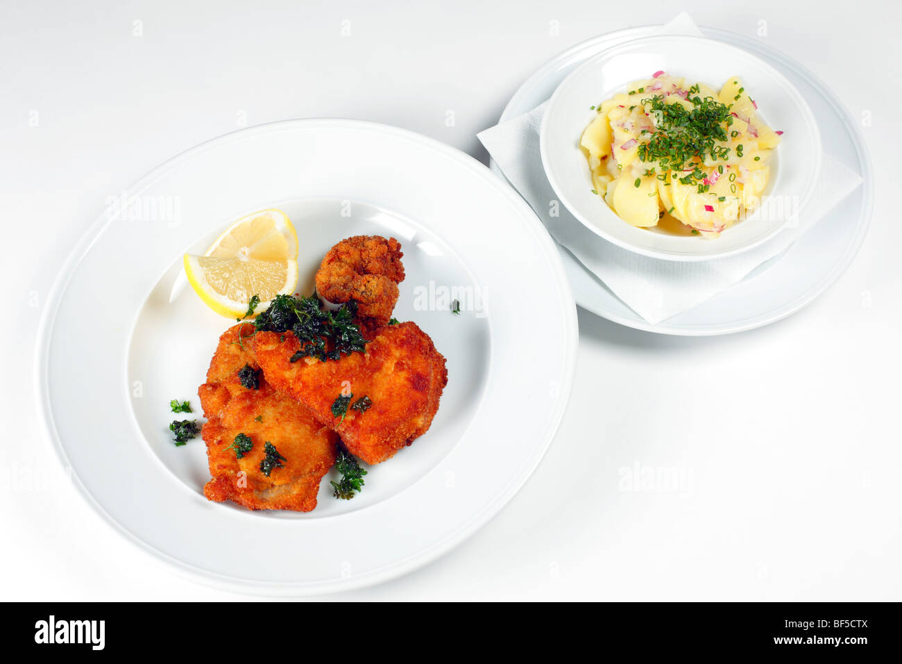 Backhendl boneless roast chicken with potato salad Stock Photo - Alamy