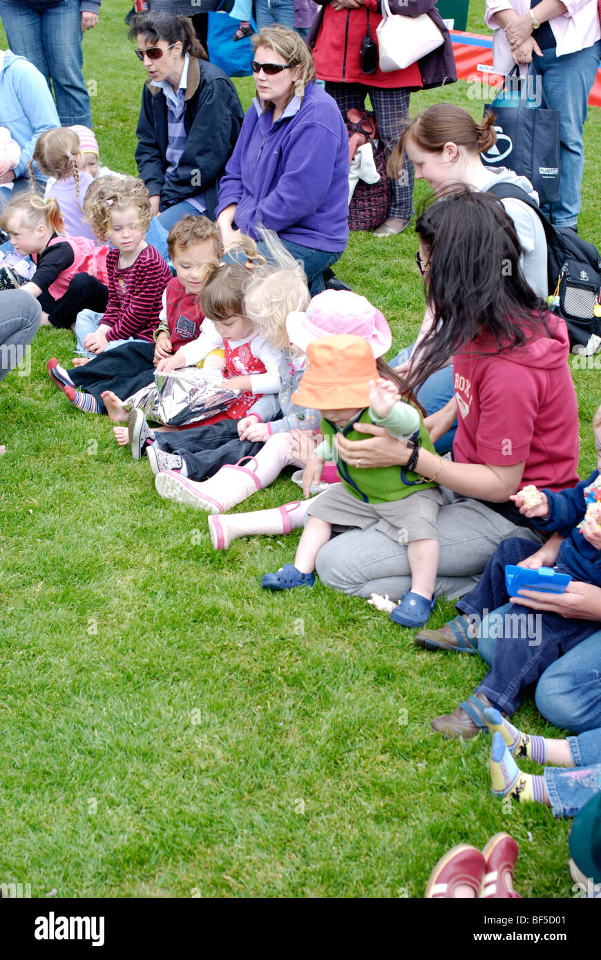 Young children and parents at a community event Stock Photo - Alamy