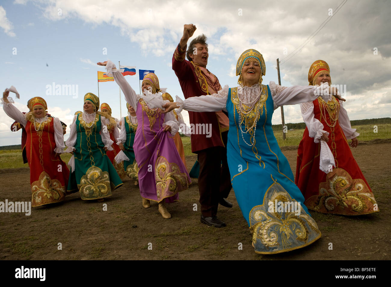 Men and women in traditional costume dancing at rural dance event in ...