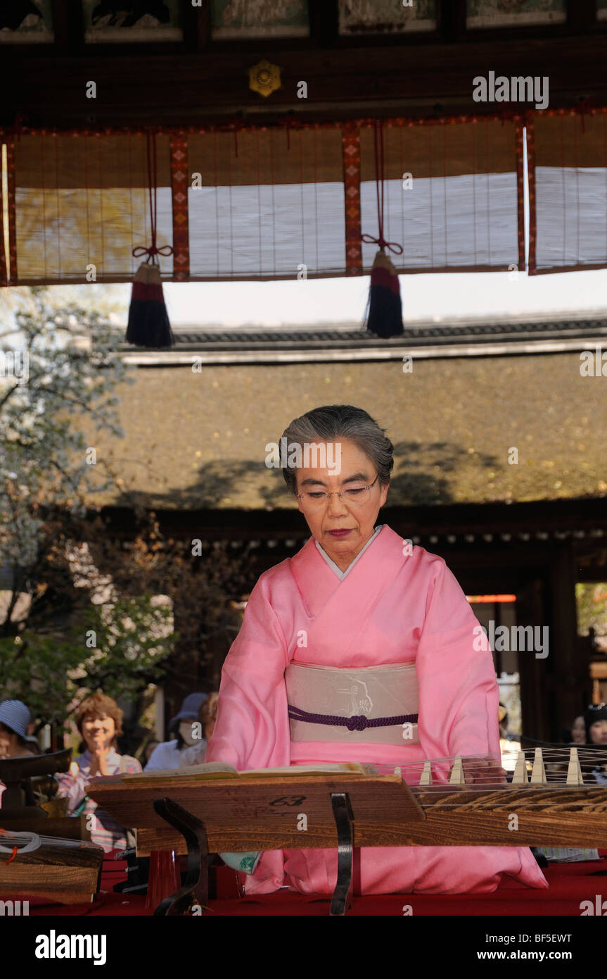 Woman playing a Koto, a traditional Japanese stringed musical ...