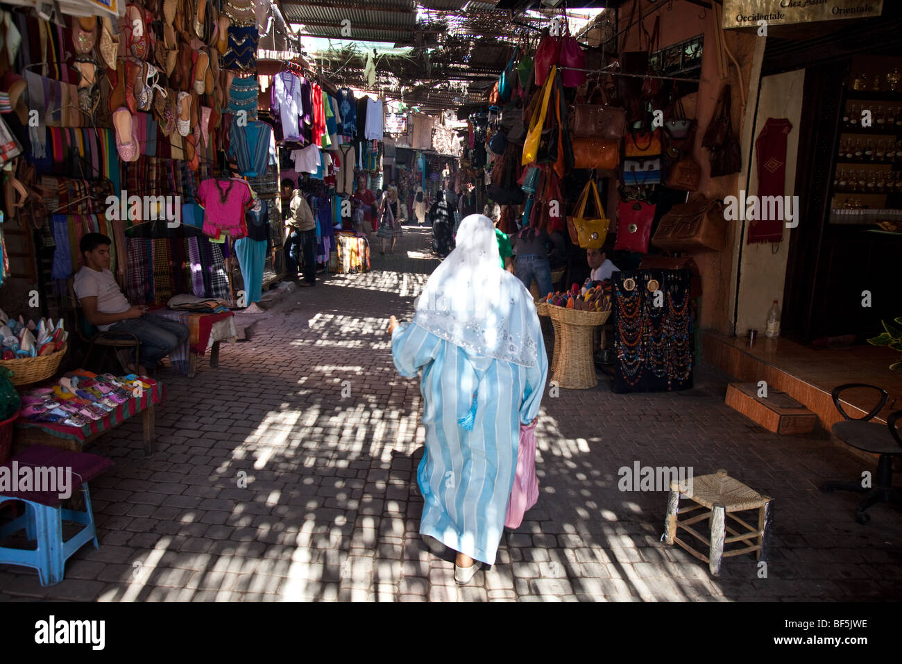 A woman in hijab walks past souk in medina of Marrakesh, Morocco Stock ...