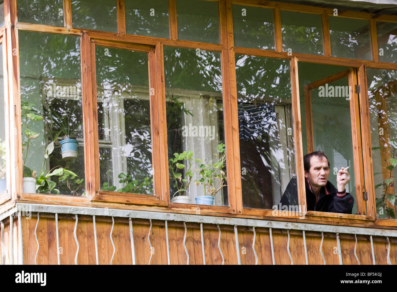 Man smoking out of open window, Ural Mash, Yekaterinburg, Russia Stock ...