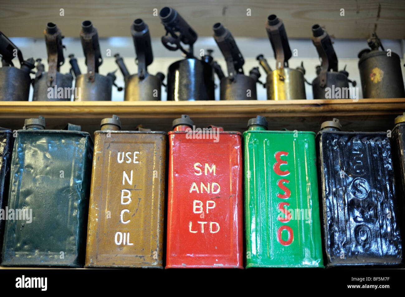 A row of old oil cans Stock Photo - Alamy