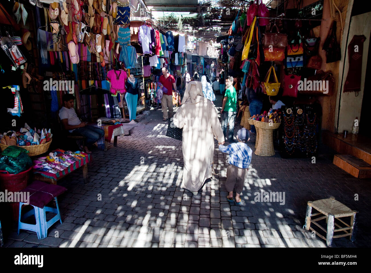 A woman in hijab walks past souk in medina of Marrakesh, Morocco Stock ...
