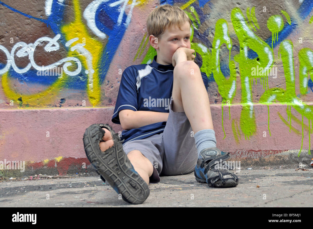 9-year-old boy, bored, football ground in Cologne, North Rhine ...