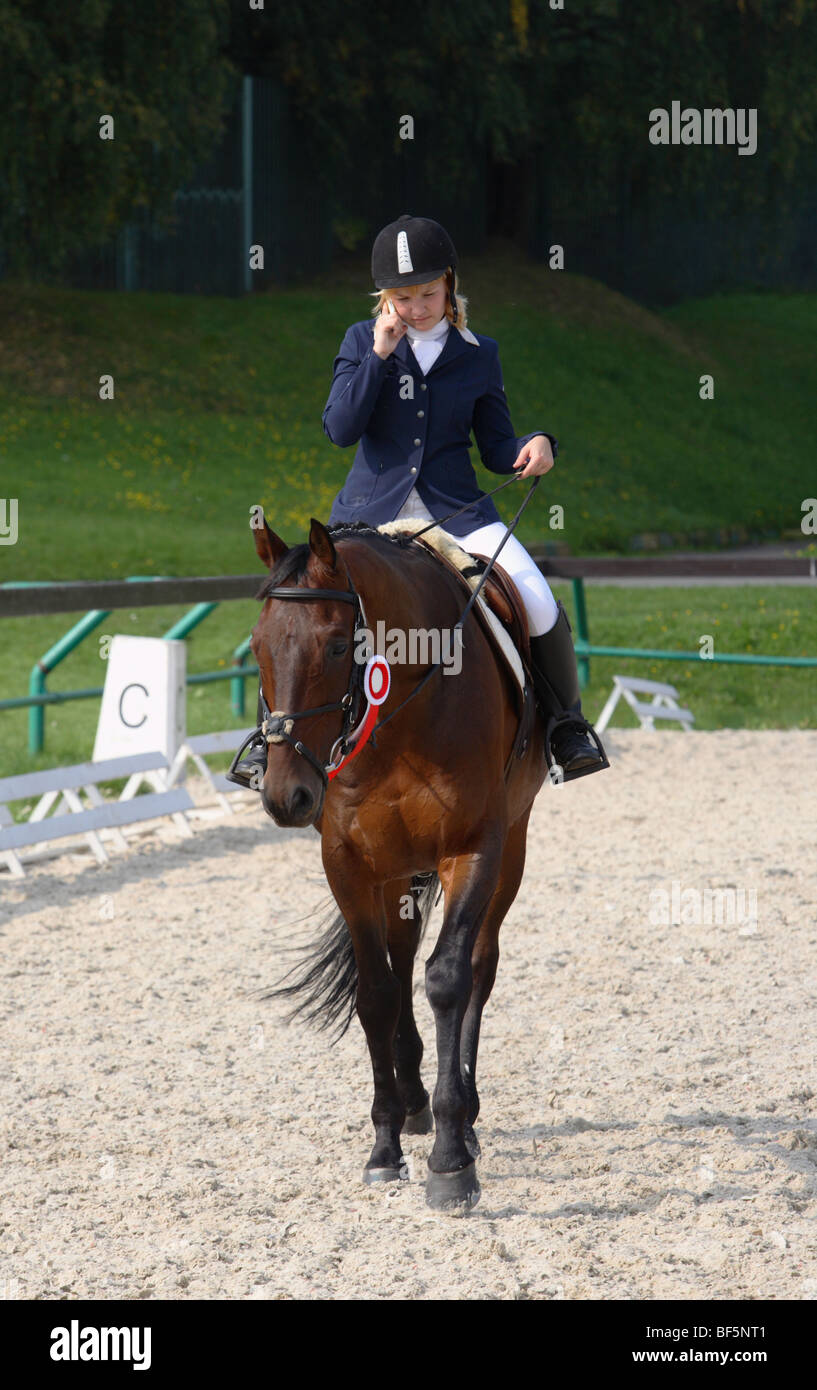 Young equestrian girl talking on the phone Stock Photo - Alamy