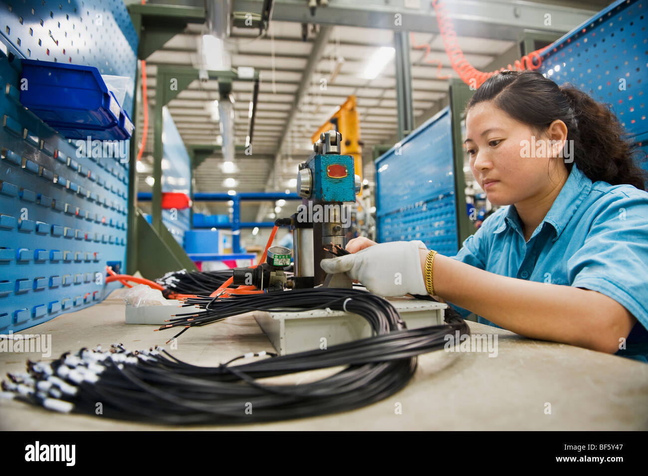 A factory employee clamping and sodding small parts Stock Photo - Alamy