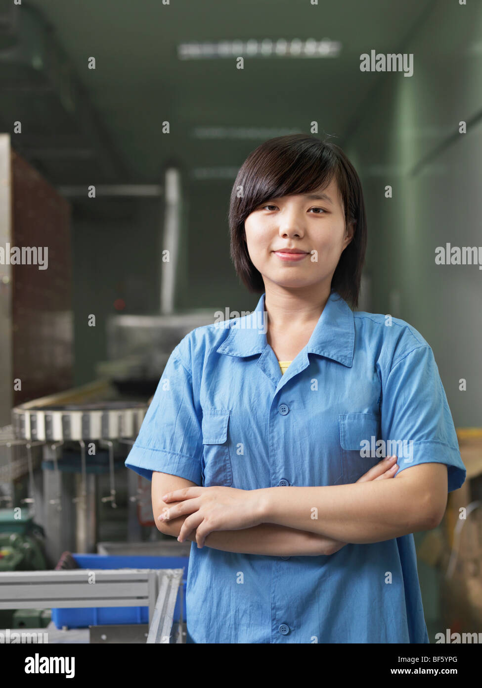 A portrait of a young factory employee in her uniform Stock Photo - Alamy