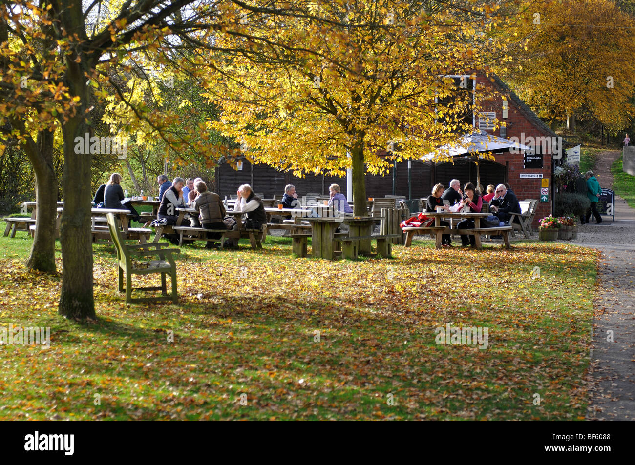 People sat outside cafe at Hatton Locks in autumn, Grand Union Canal ...