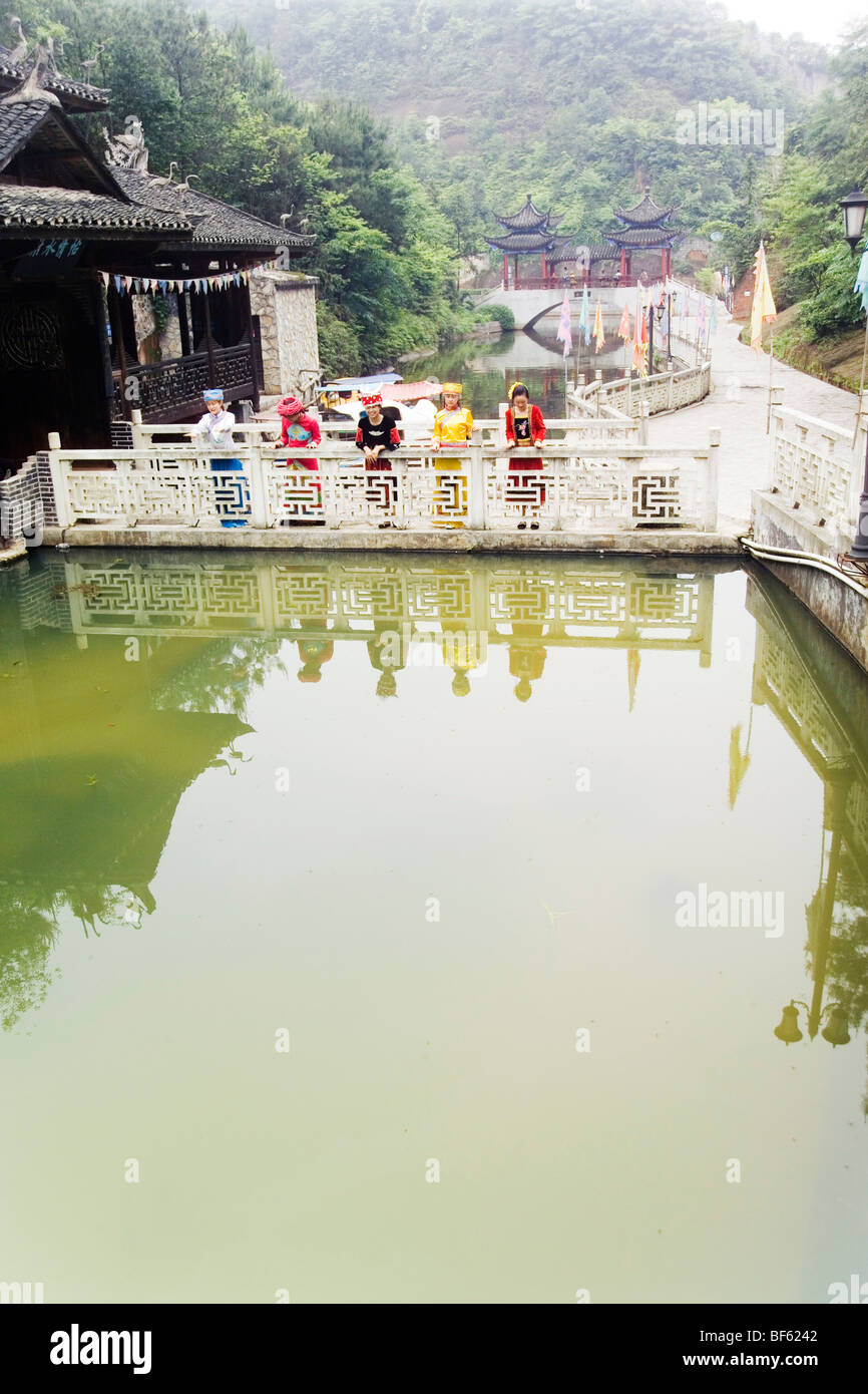 Tujia woman wearing traditional costume on bridge, Tusi City, Enshi ...