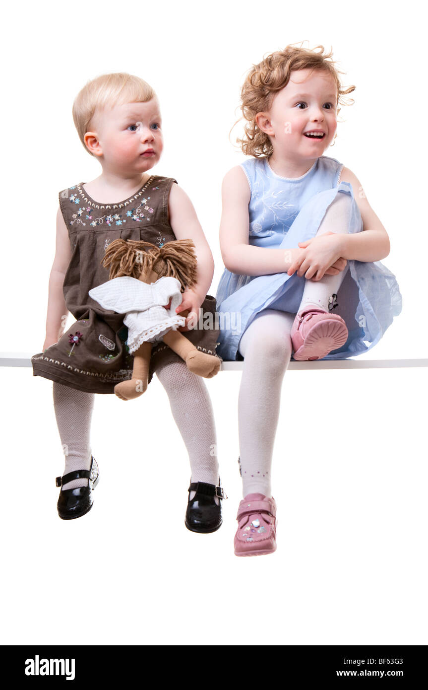 Studio photo of two sisters isolated on white Stock Photo - Alamy