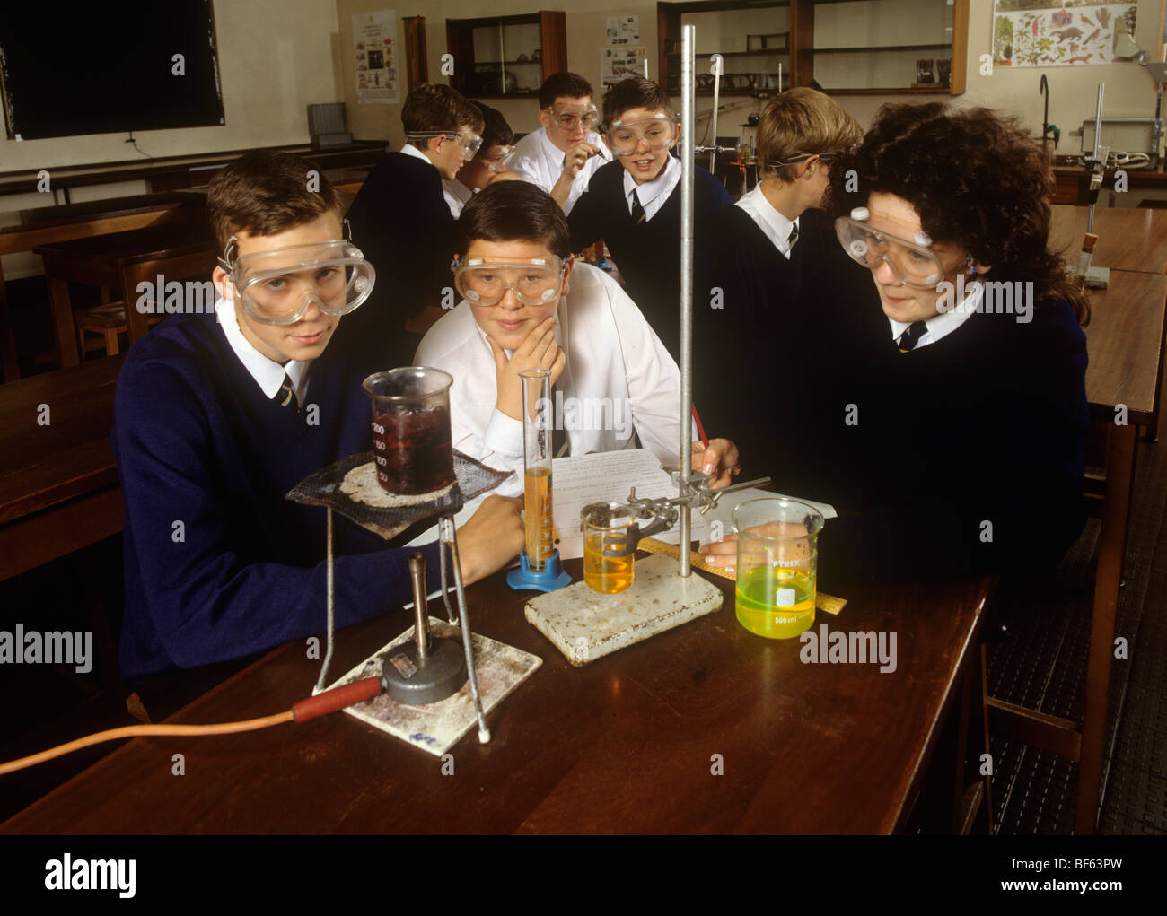Education, school students conducting experiment in a chemistry ...