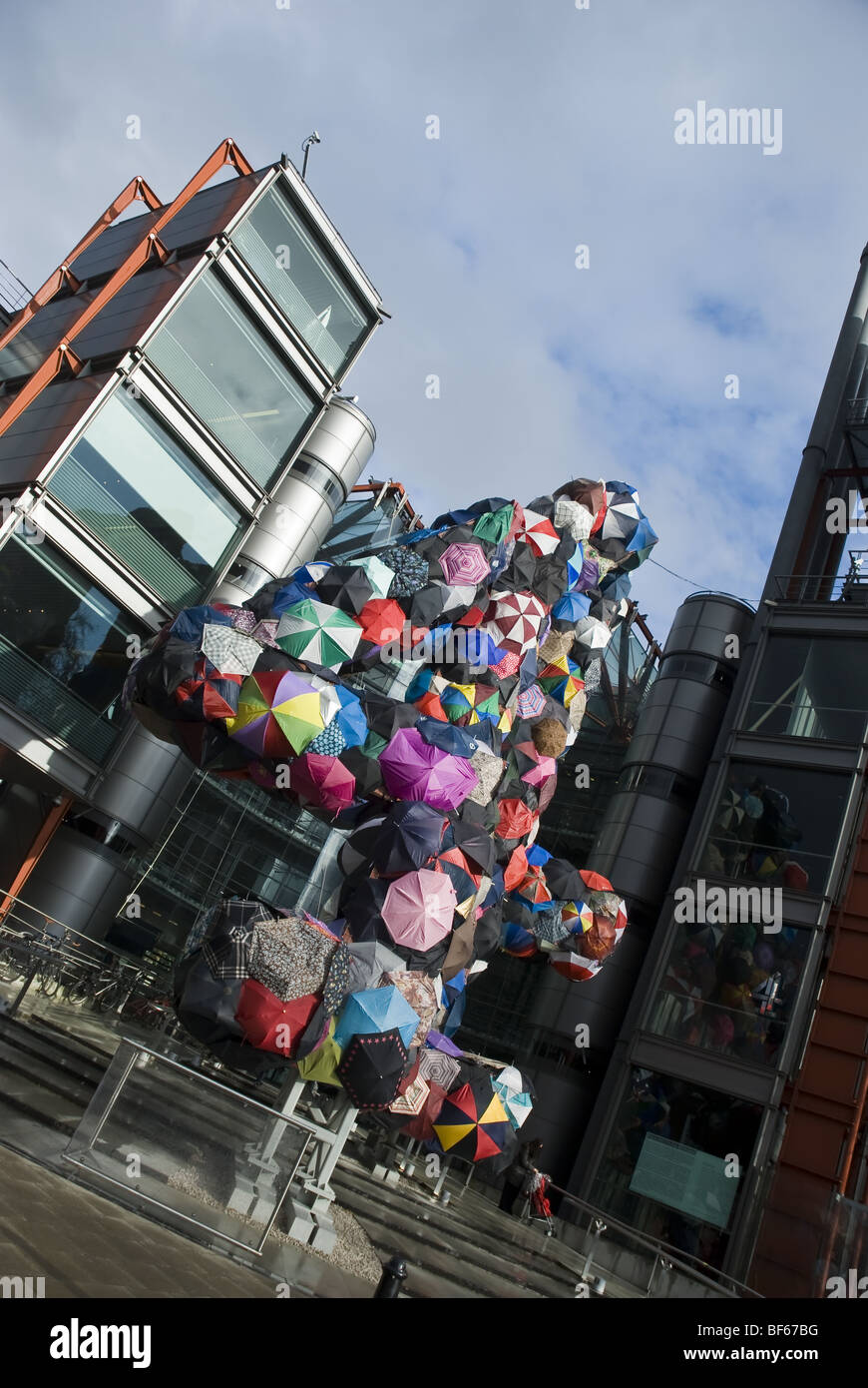 The Channel 4 building in London, with a statue covered in umbrellas in ...