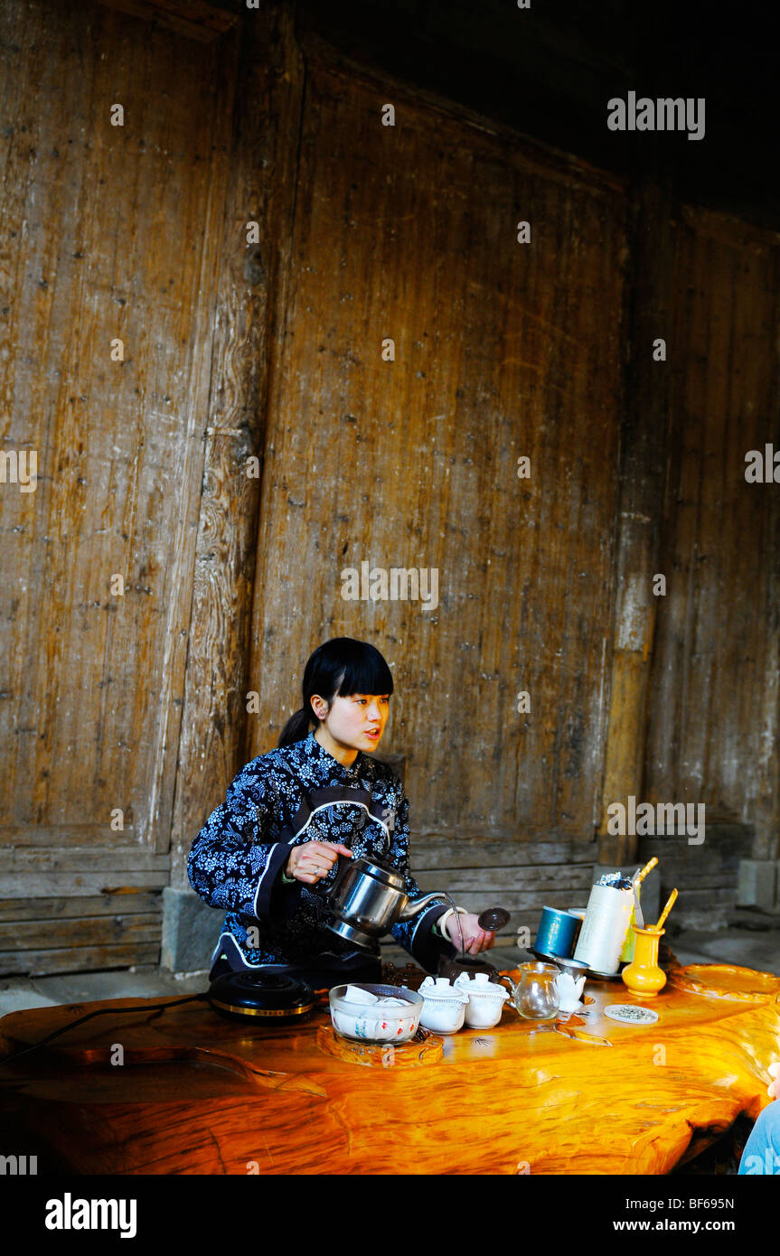 Chinese woman in traditional clothing making tea, Jiang Family Ancient ...