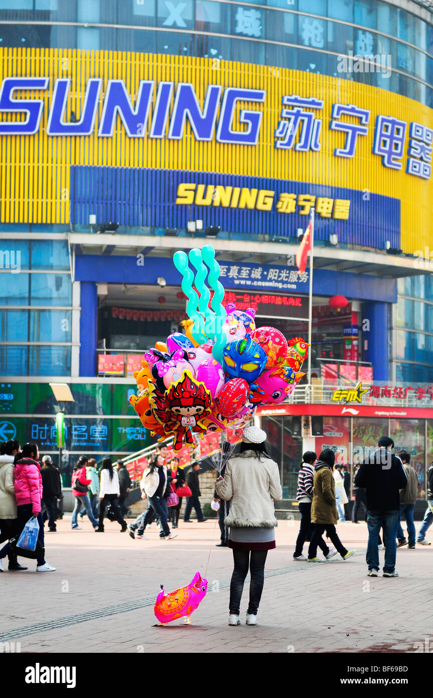 Chinese girl selling balloon in Huangxing South Road Shopping Street ...