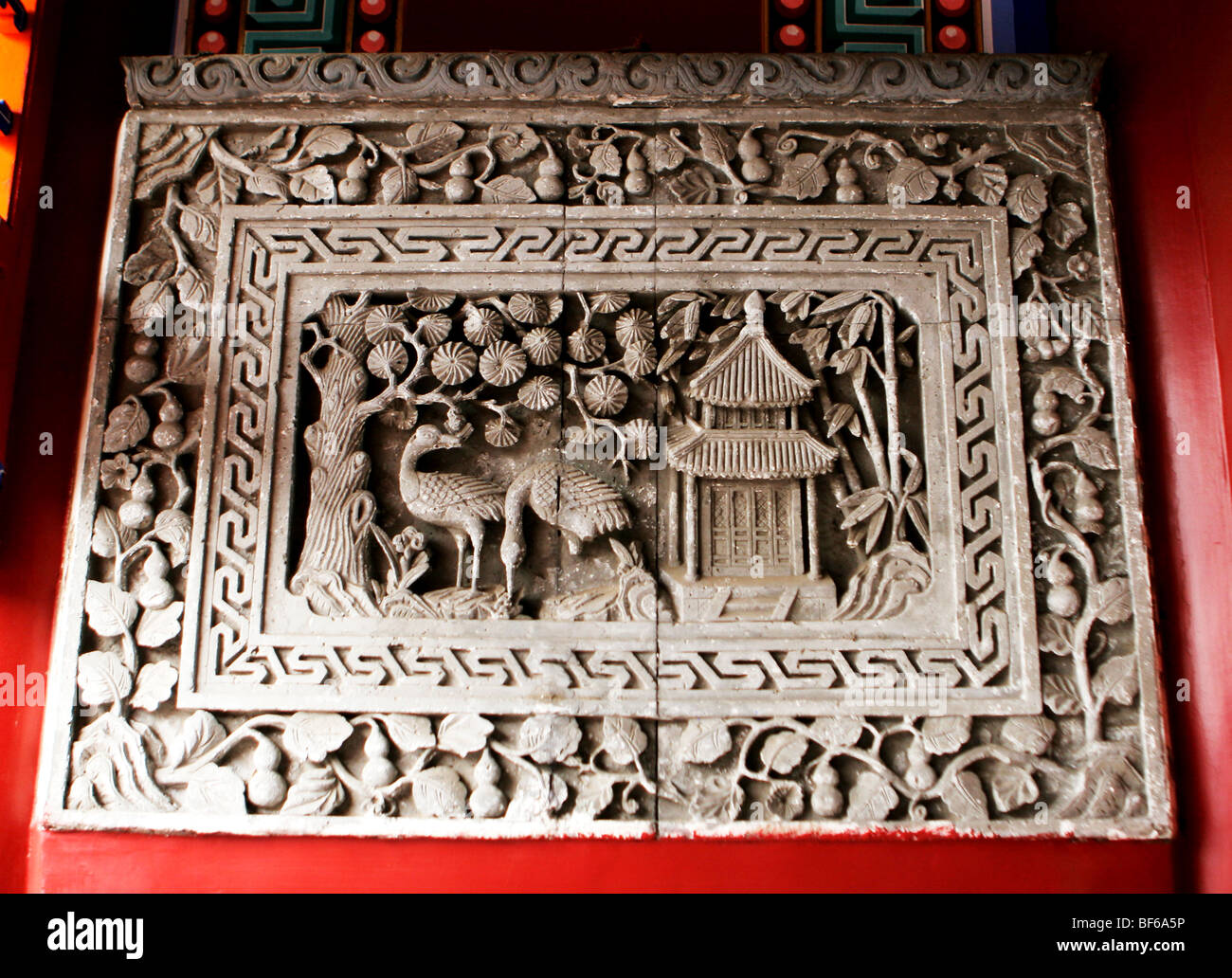 Elaborate carved brick relief over a corridor with pine and crane ...