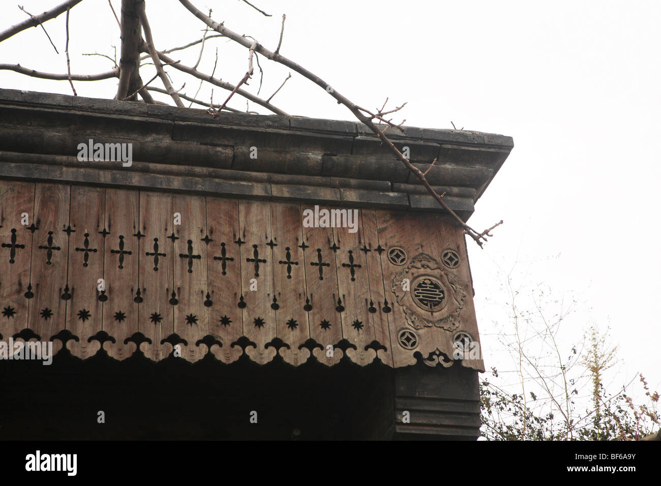 Old wooden panel carved with traditional Chinese patterns of a Hutong ...