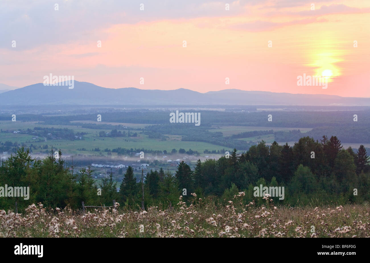 Pink sunset and countryside landscape Stock Photo - Alamy