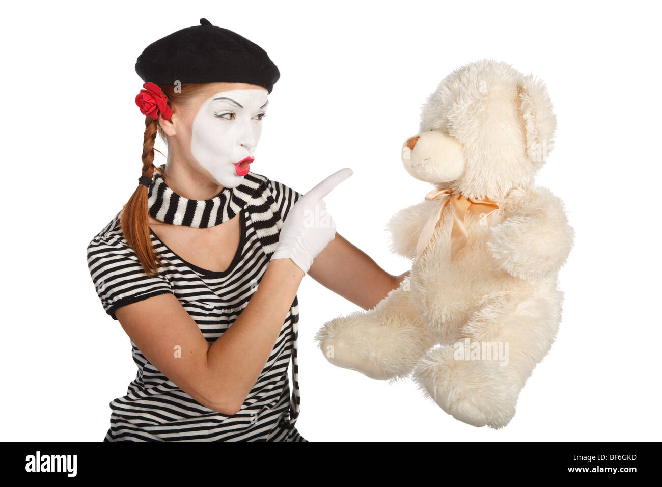 Portrait of a young lady dressed up as a mime isolated on white ...