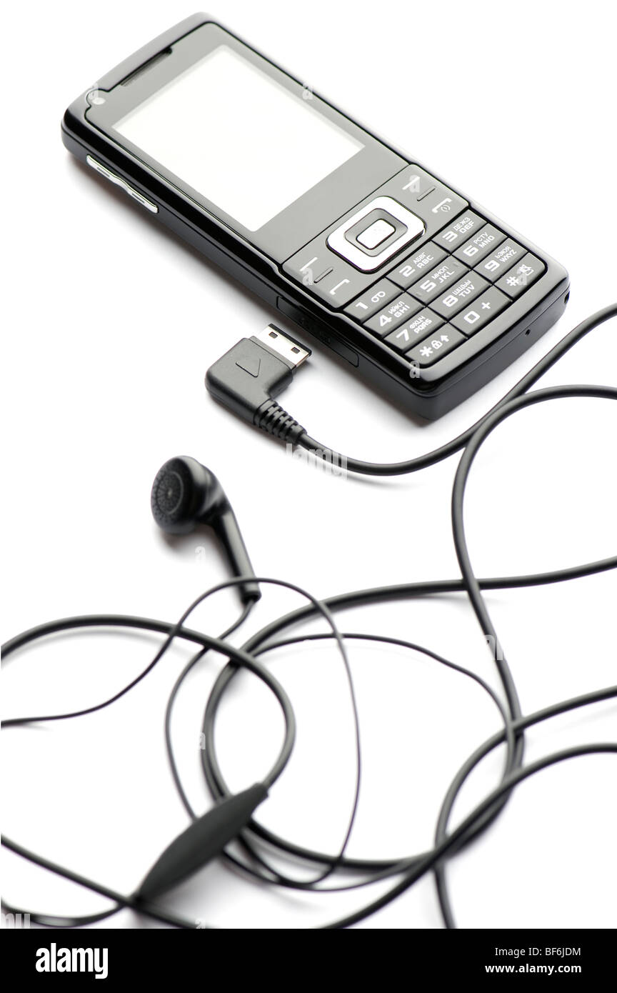 object on white - mobile phone with head set Stock Photo - Alamy