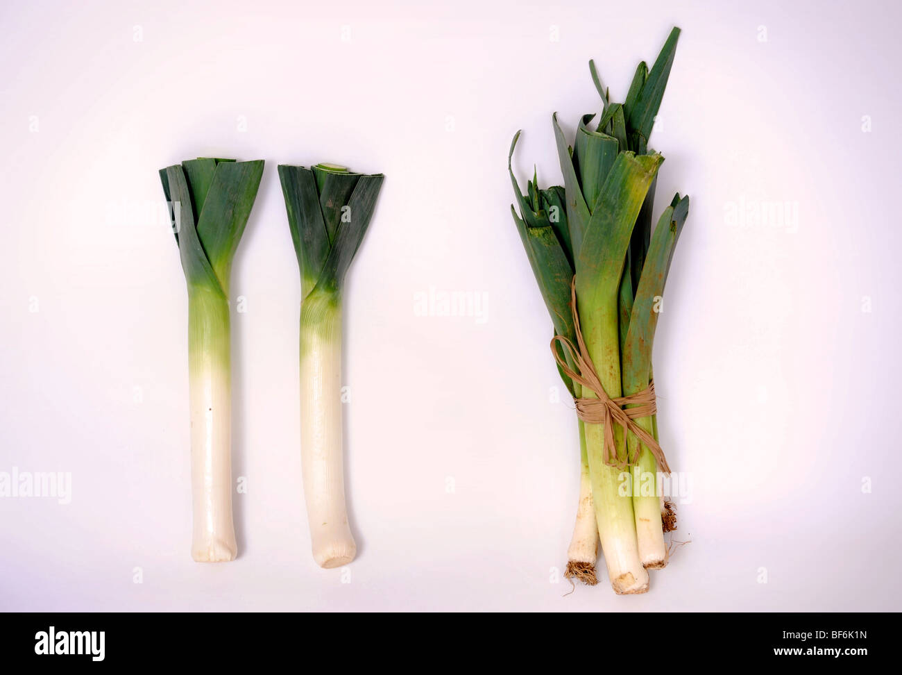 Leeks presented for sale in differing ways with uniform supermarket ...