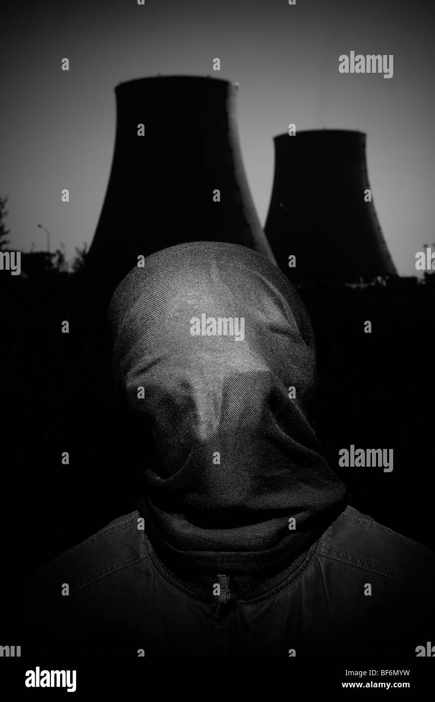 Hooded man near nuclear power plant Stock Photo - Alamy