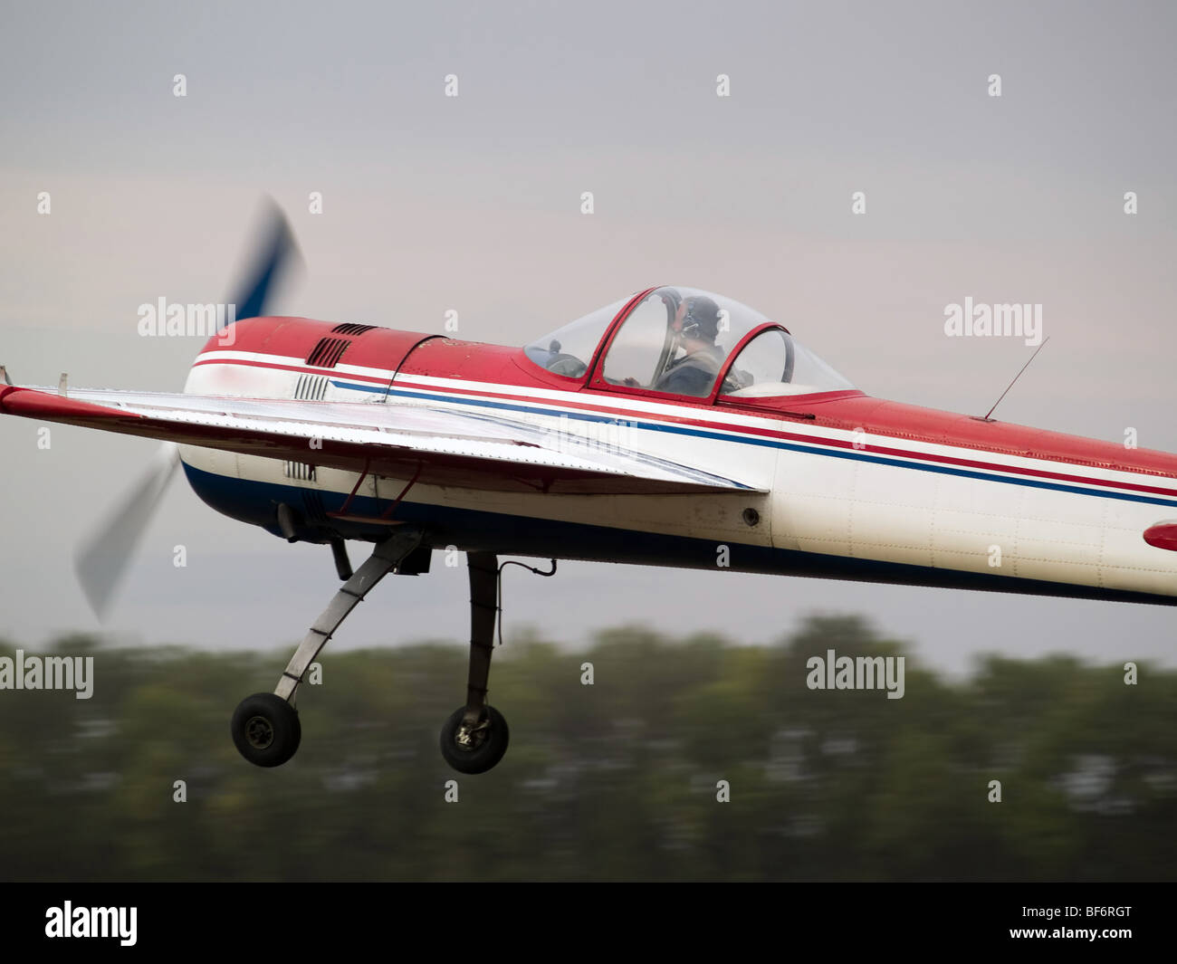 Small aerobatics plane performing speed pass low altitude Stock Photo ...