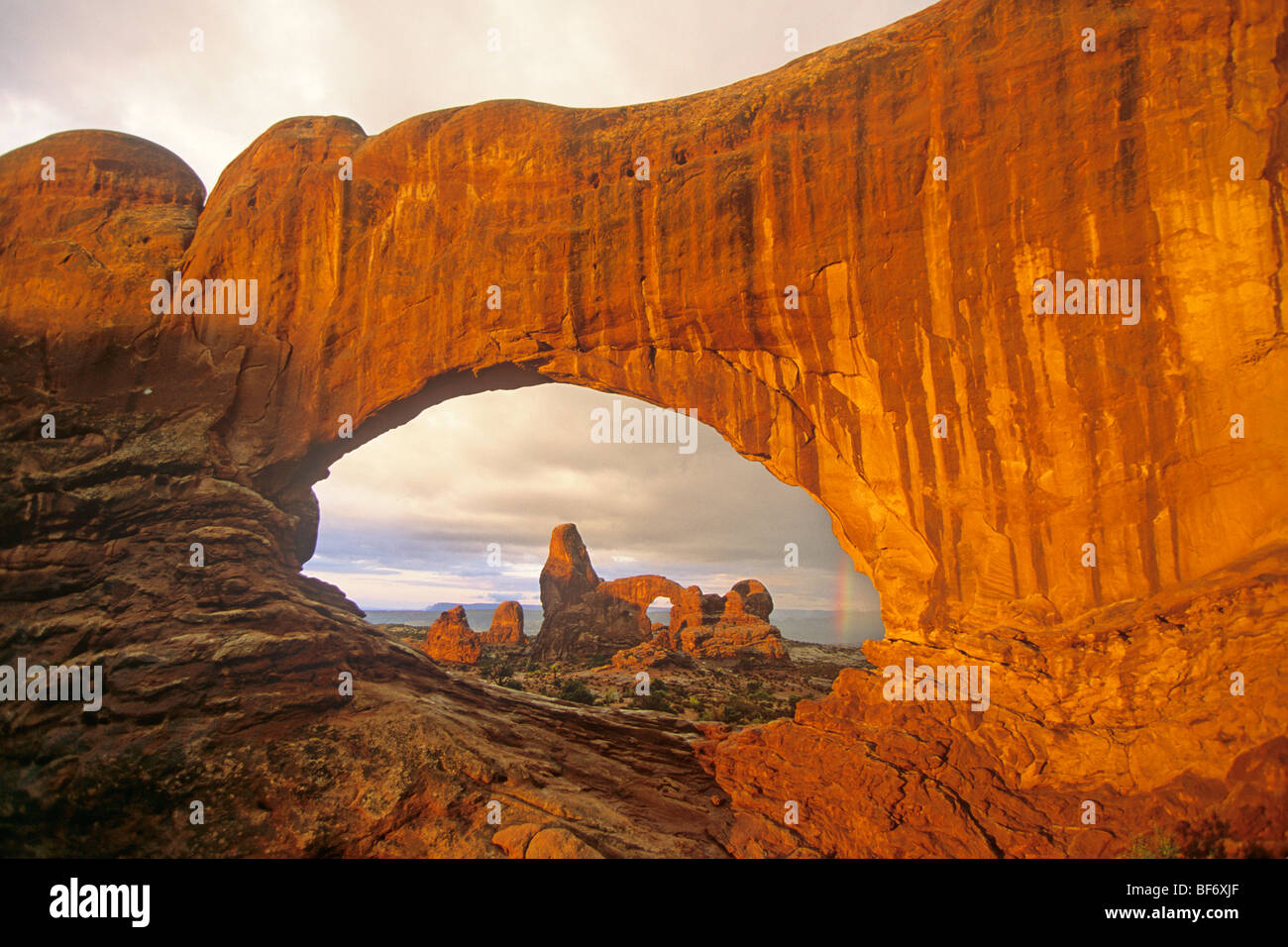 Turret Arch with rainbow viewed through North Window at Arches National ...