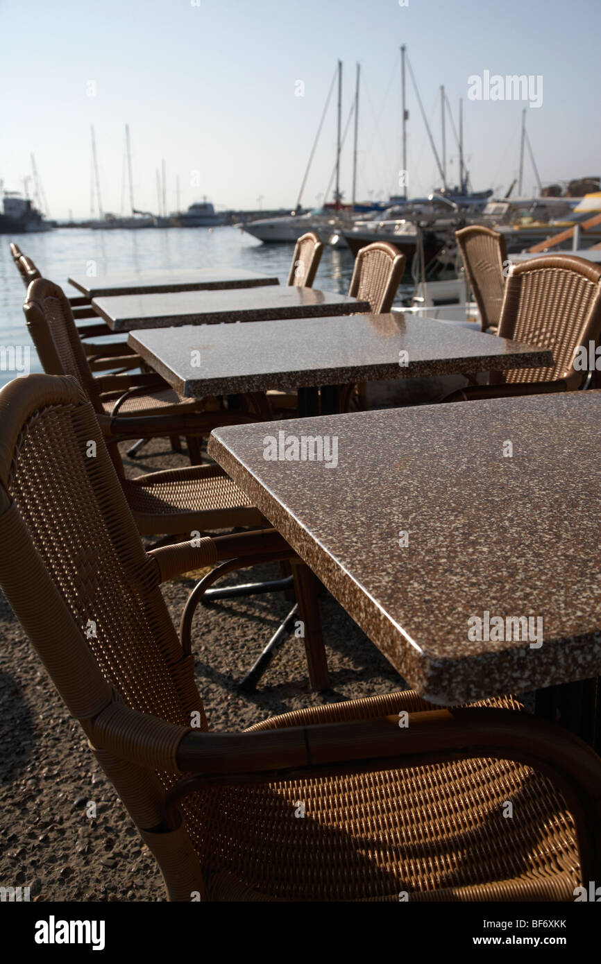empty outdoor cafe tables next to paphos harbour marina republic of ...