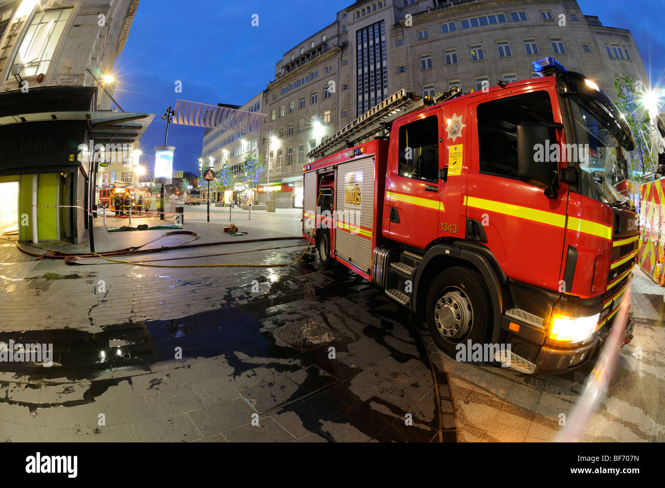 Fisheye view of fire engines at large building fire at night Stock ...