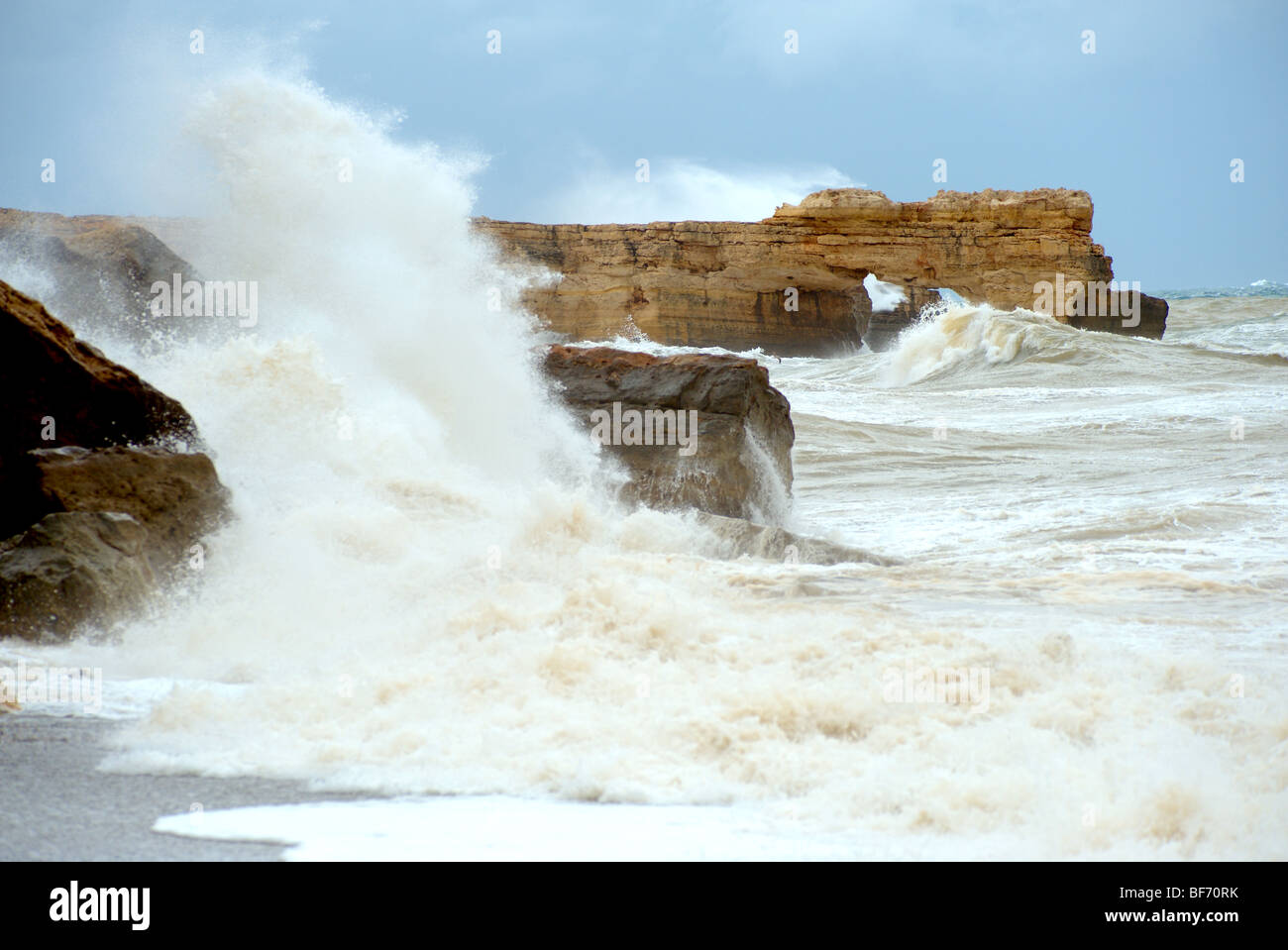 Natural limestone arch and storm tossed wild sea Stock Photo - Alamy