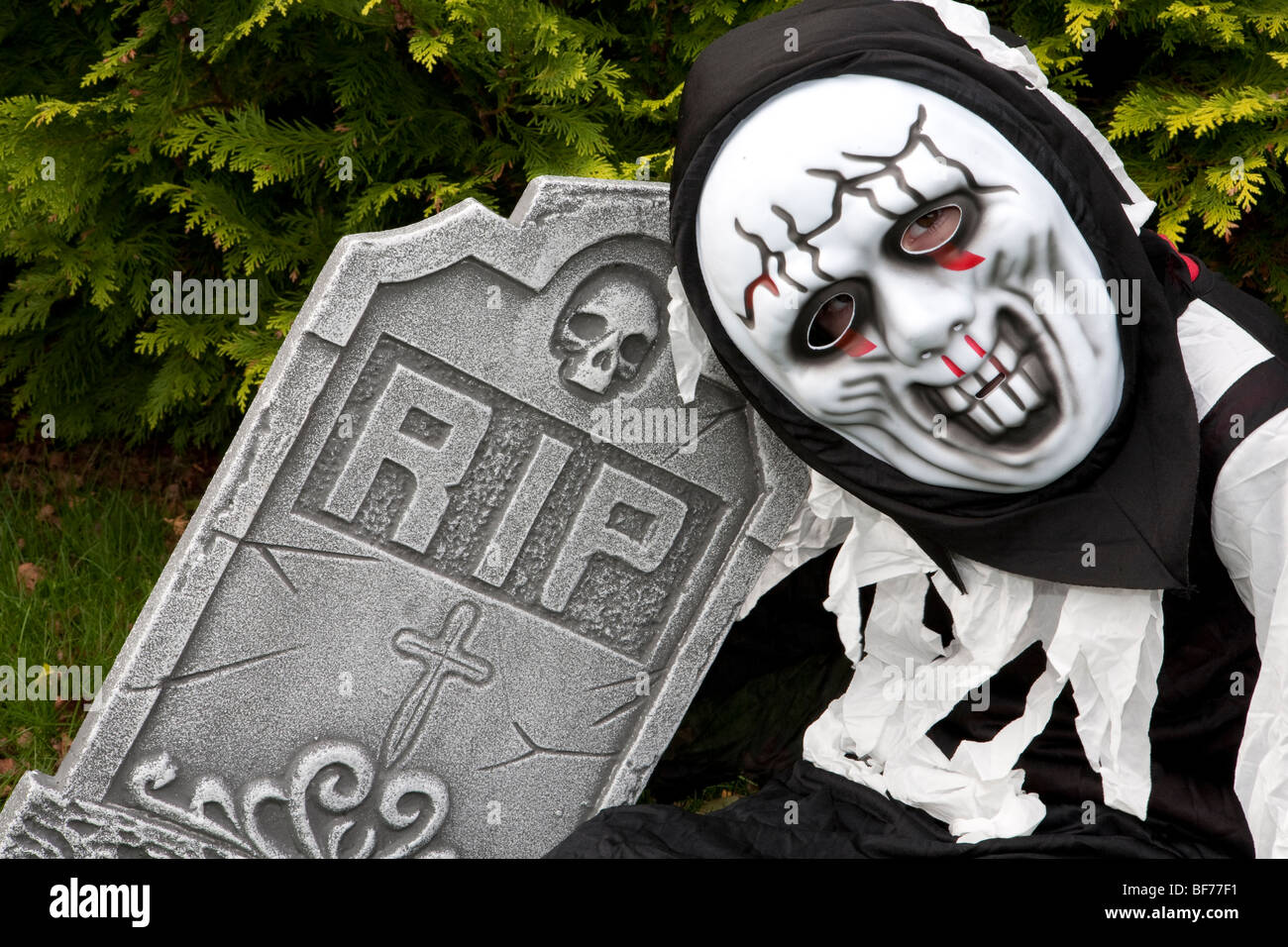 Halloween mask and RIP grave headstone Stock Photo - Alamy