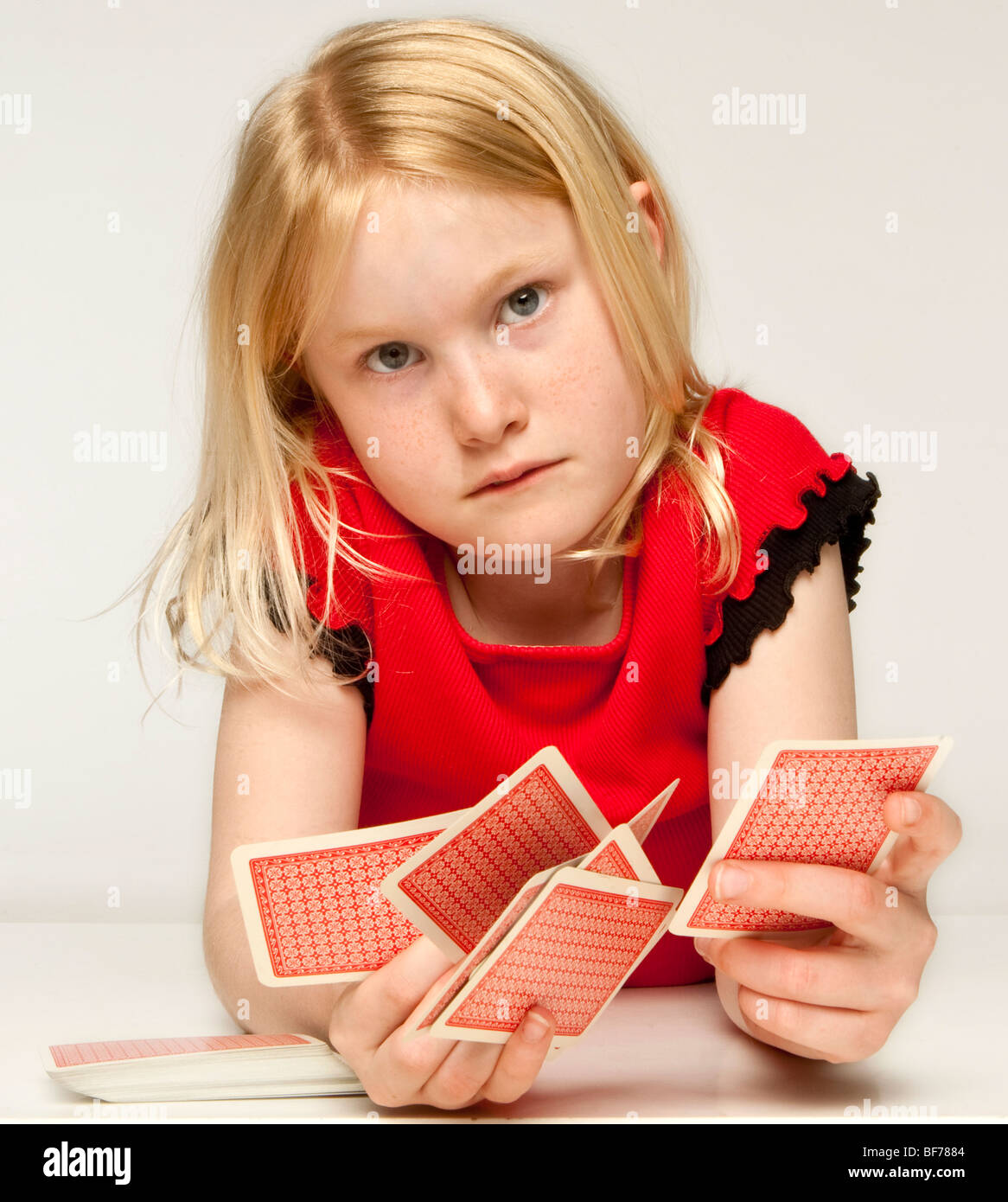 Child hand holding playing cards hi-res stock photography and images ...