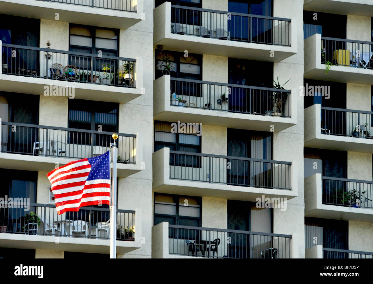 Usa flag against apartments in Miami Stock Photo - Alamy