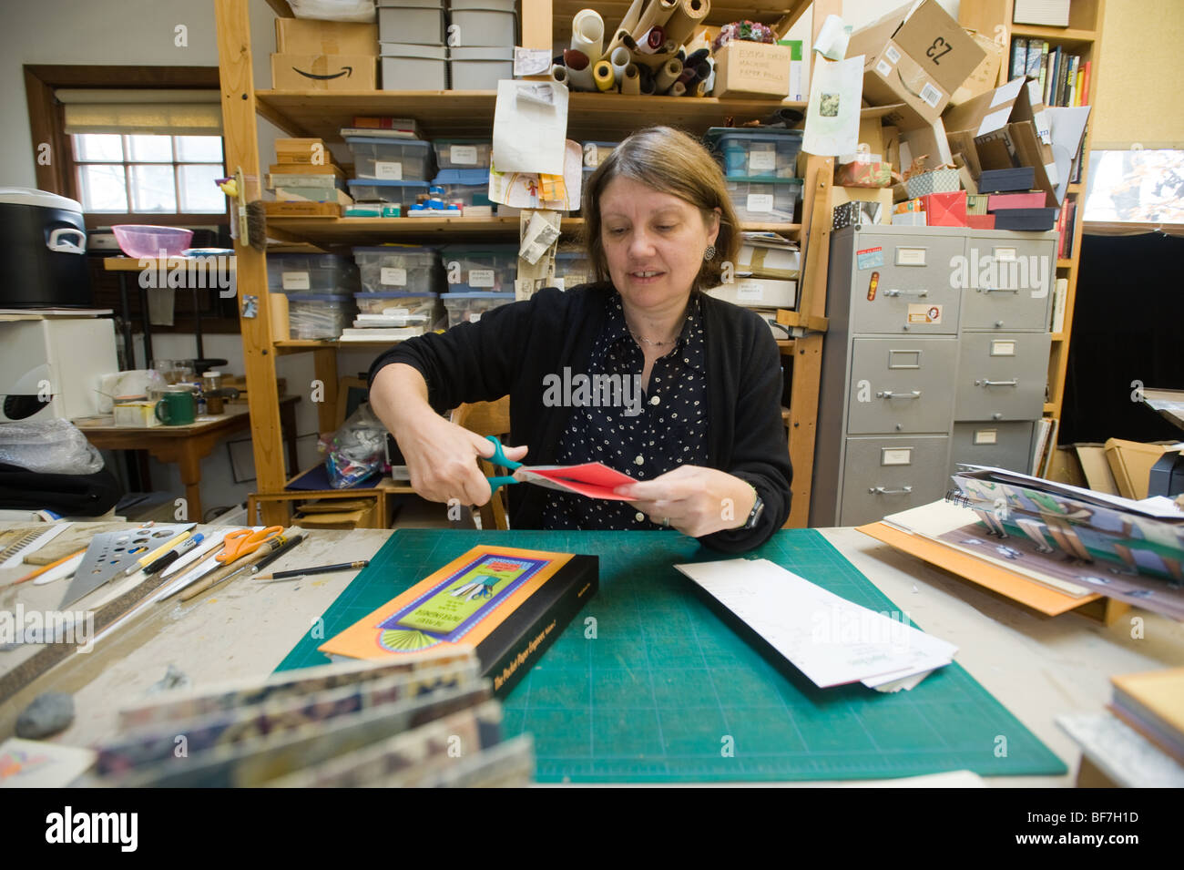 Woman cutting paper Stock Photo - Alamy