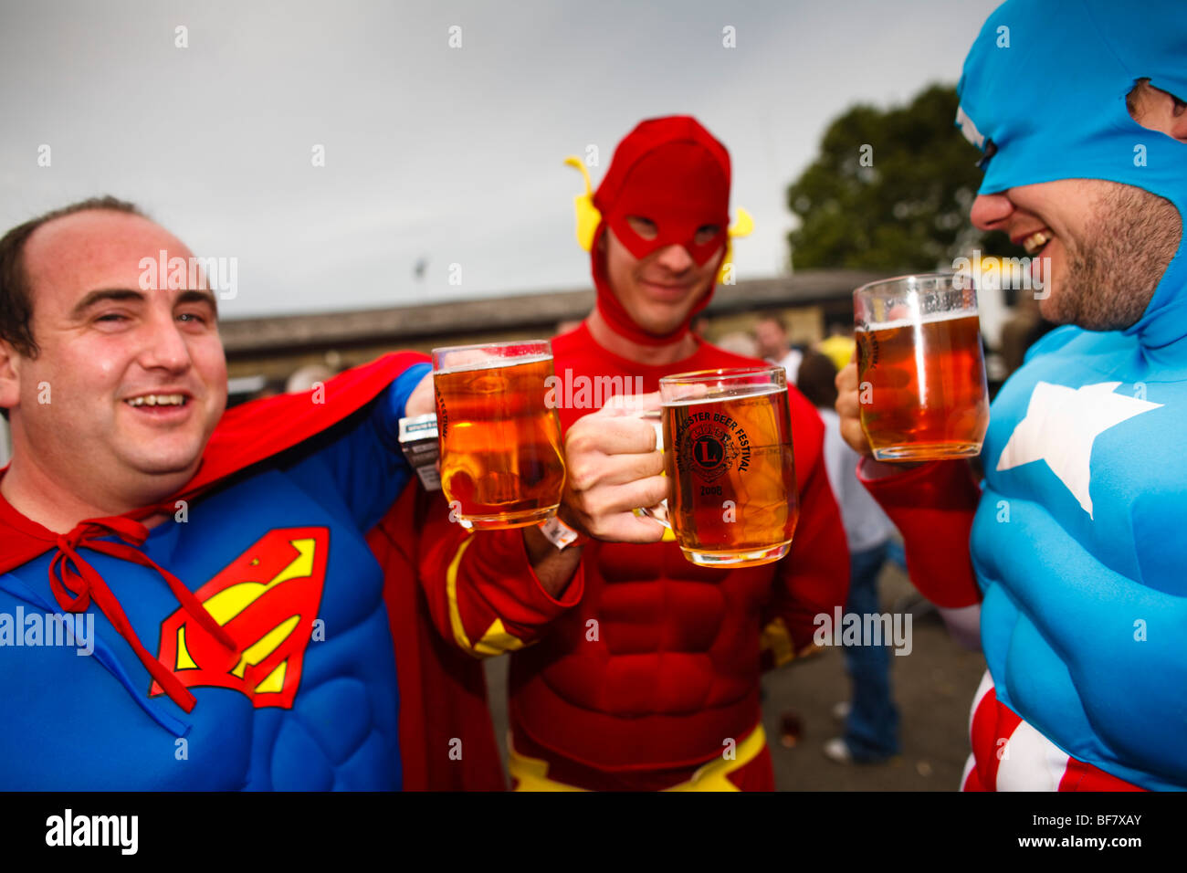 Drunk men dressed as superheroes drinking beer at Saul beer festival ...