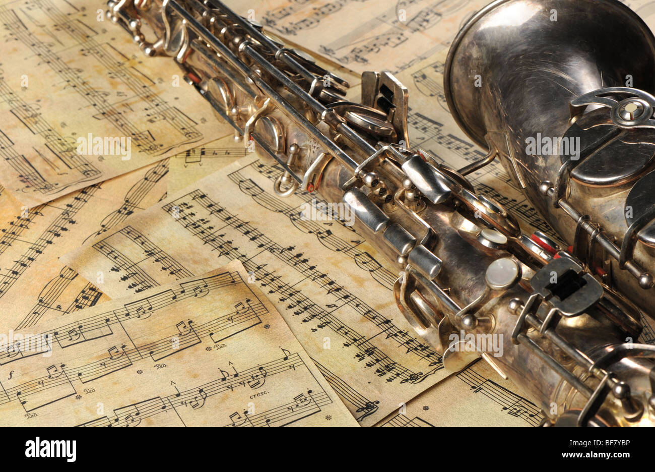 Old saxophone and notes. The Musical instrument laying on notes with ...