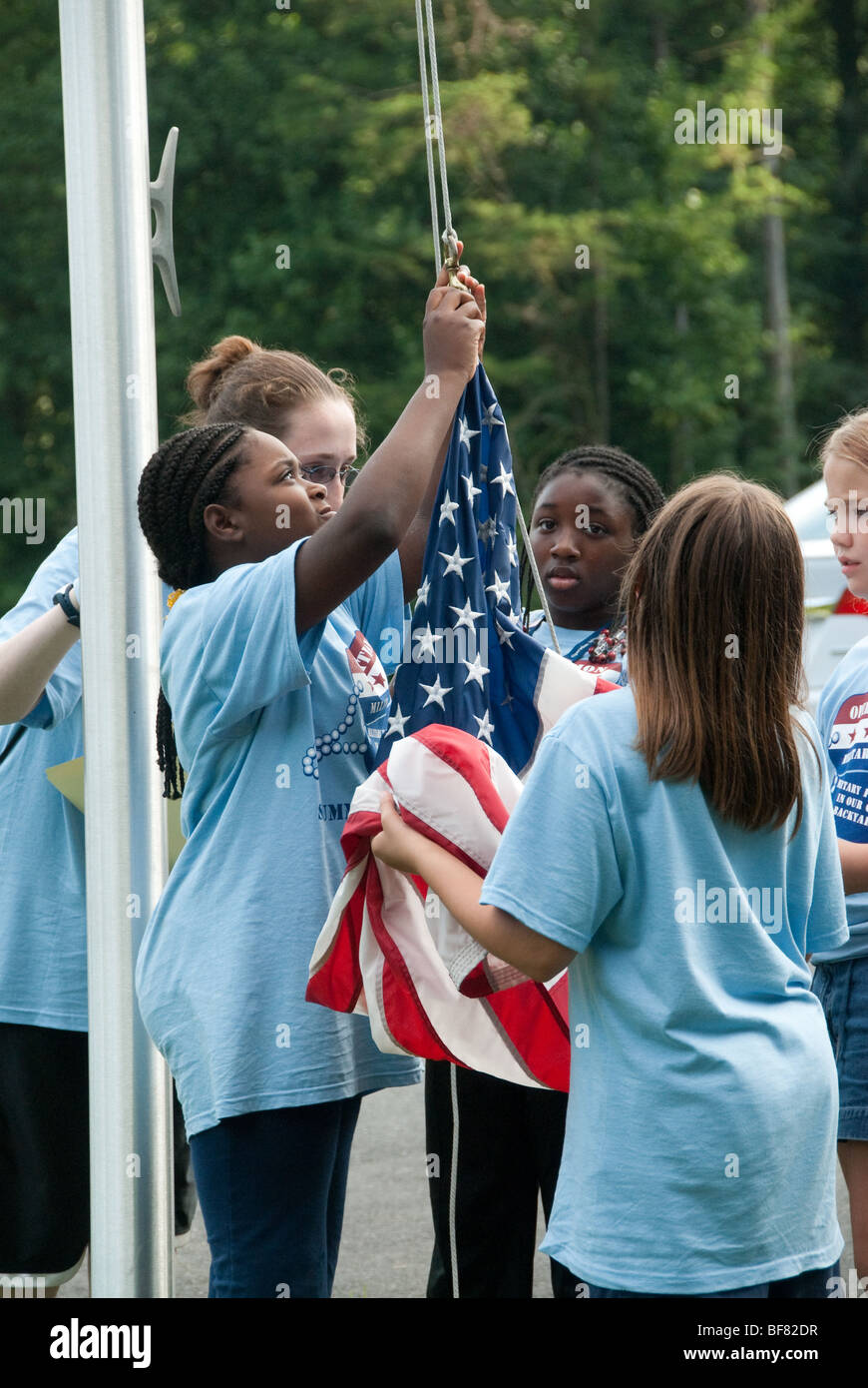 Children lowering US flag Stock Photo - Alamy