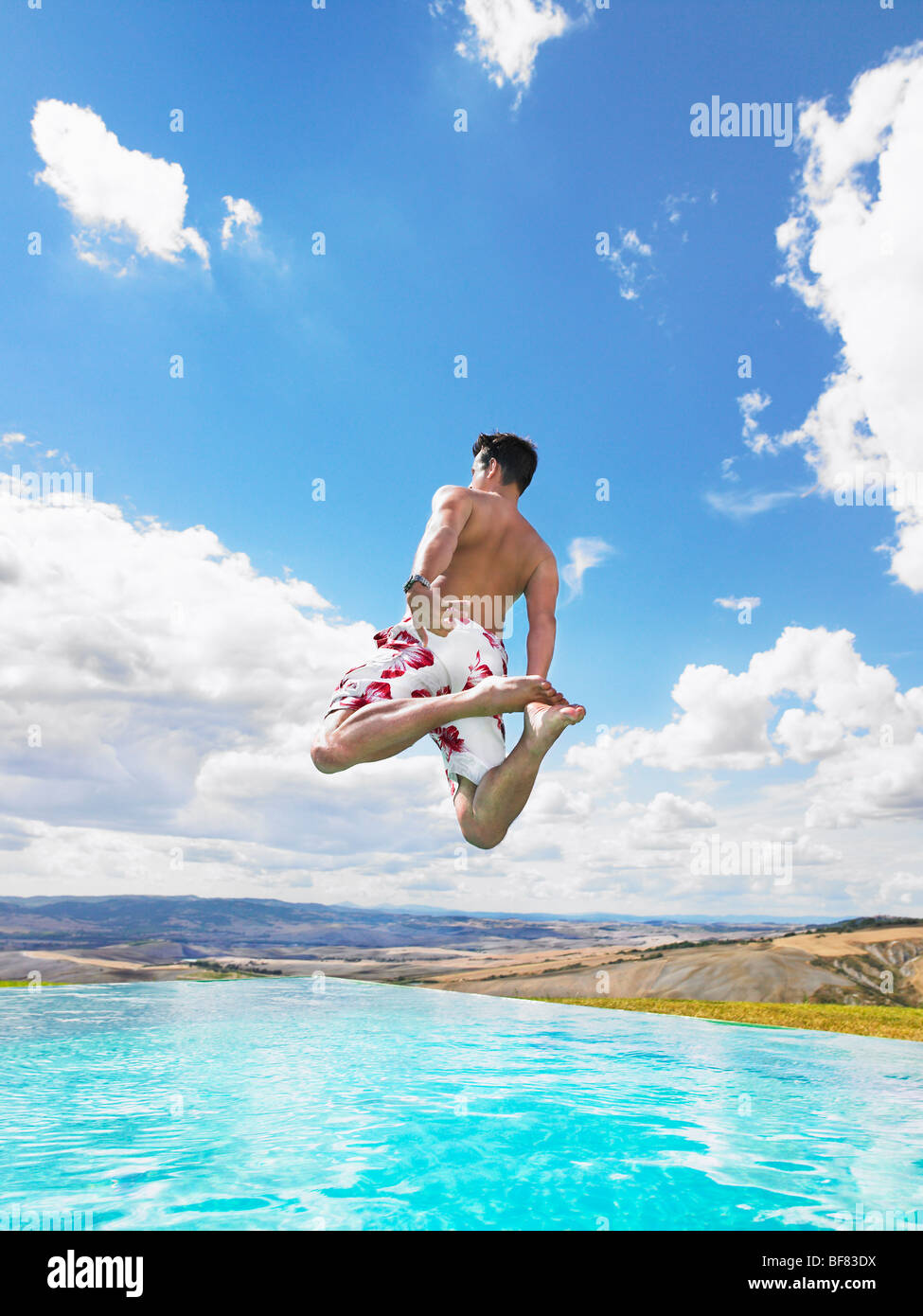 Man jumping in swimming pool Stock Photo - Alamy